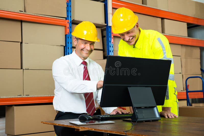 Happy Warehouse Worker and Manager Using Computer Stock Photo - Image ...