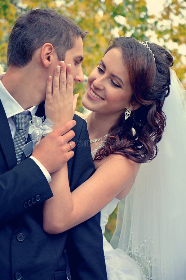 Wedding Couple. Charming Bride and Groom Sitting on a Bed Stock Photo ...