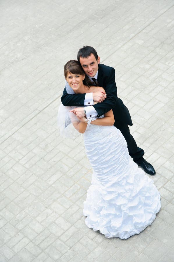Happy Wedding Couple Standing and Embracing Stock Photo - Image of ...