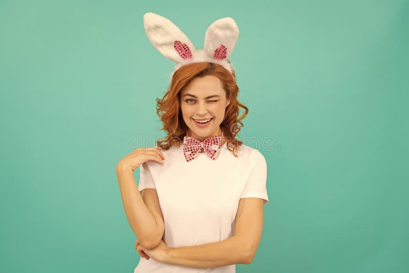 Happy Winking Easter Girl In Bunny Ears And Bow Tie On Blue Background