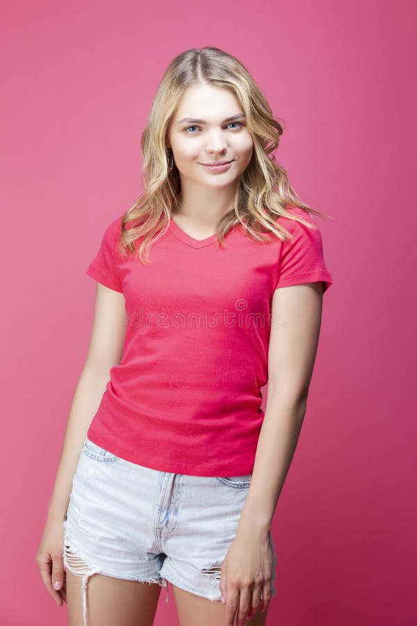 Happy Winsome Caucasian Blond Girl In Coral T Shirt Posing In Summer