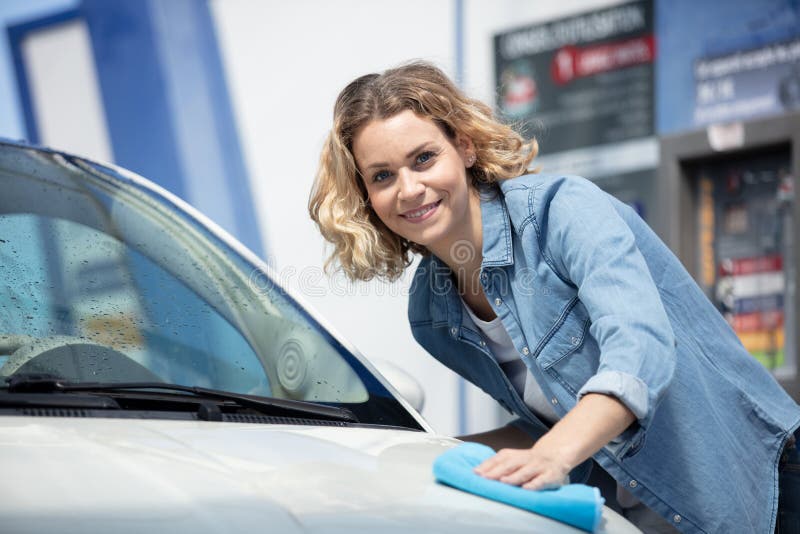 Happy woman cleaning car stock image. Image of daytime - 262851025