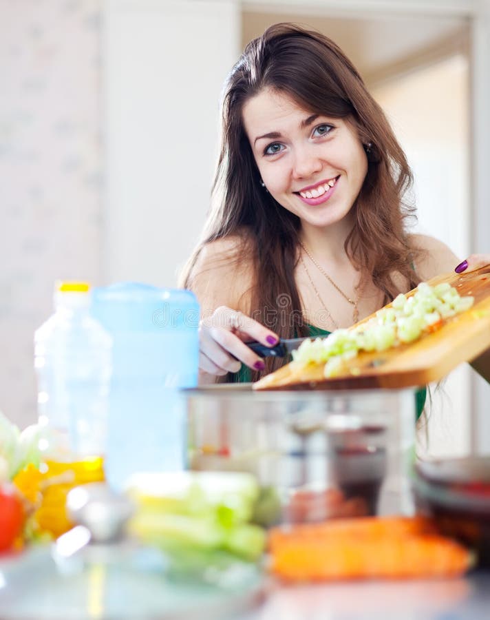 Happy woman cooking dinner stock photo. Image of look - 31093590