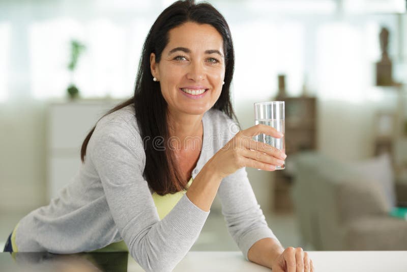 Happy Woman Drinking Water at Home Stock Photo - Image of sofa ...