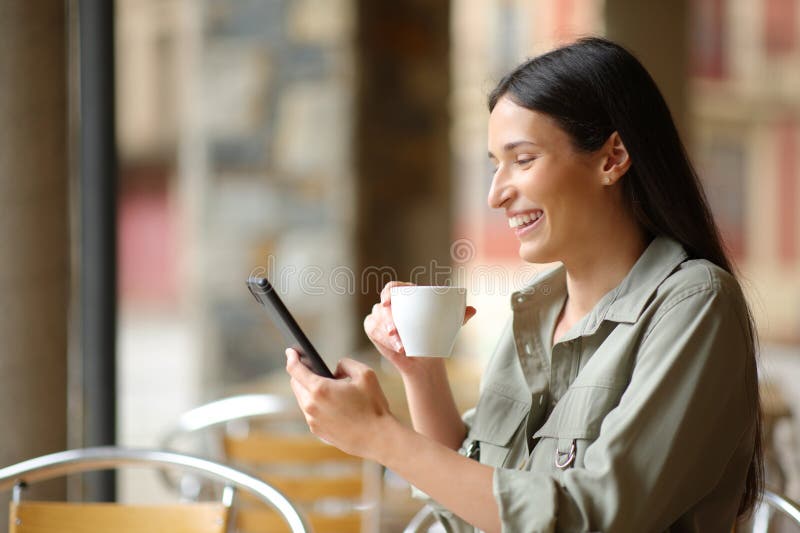 Happy Woman Drinks Coffee in a Bar Using Phone Stock Image - Image of ...
