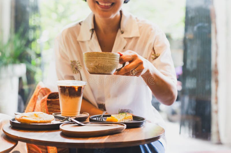 Happy Woman Drinks Coffee and Eats Cake in Cafe. Stock Image - Image of ...
