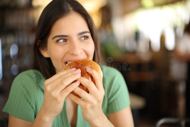 Happy Woman Eating Burger in a Restaurant Stock Photo - Image of woman ...