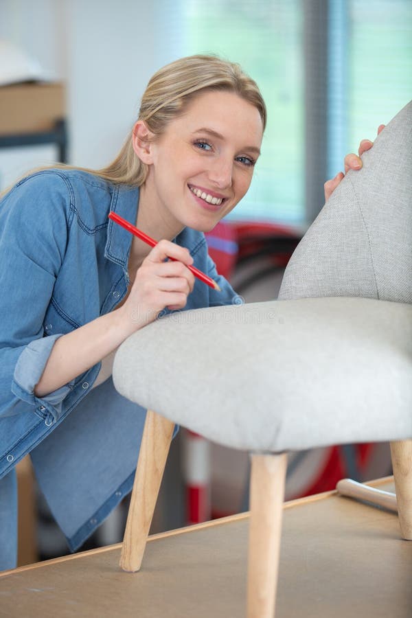 Happy woman fixing chair stock image. Image of pencil - 258026511