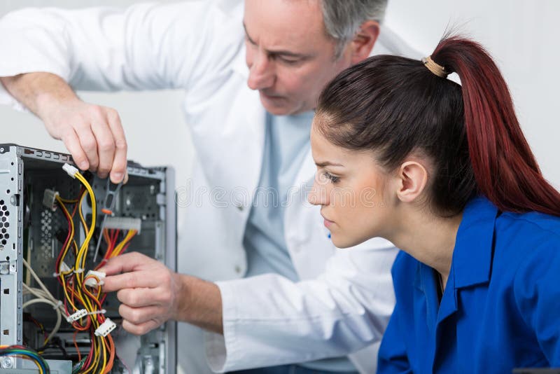 Happy Woman Fixing Computer at Desk at Work Stock Photo - Image of ...