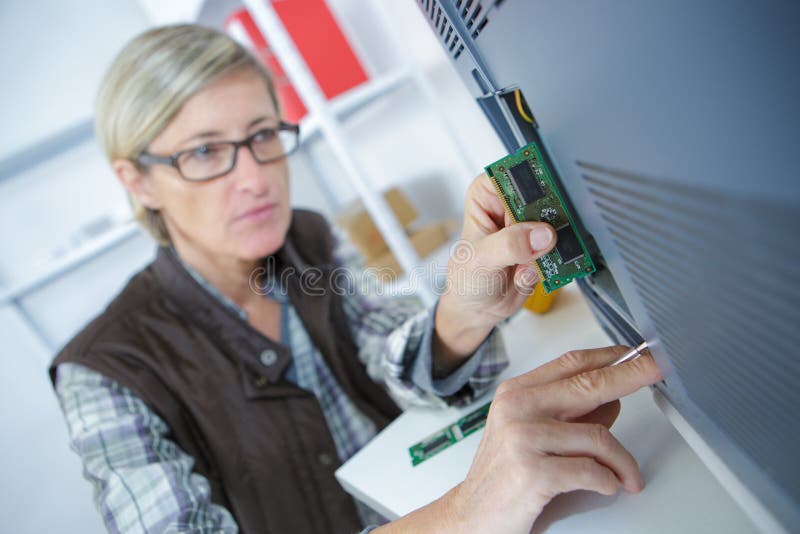 Happy Woman Fixing Computer at Desk at Work Stock Photo - Image of ...
