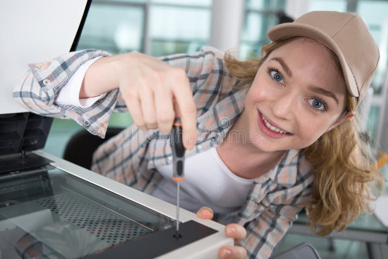 Happy woman fixing printer stock image. Image of indoors - 223326563