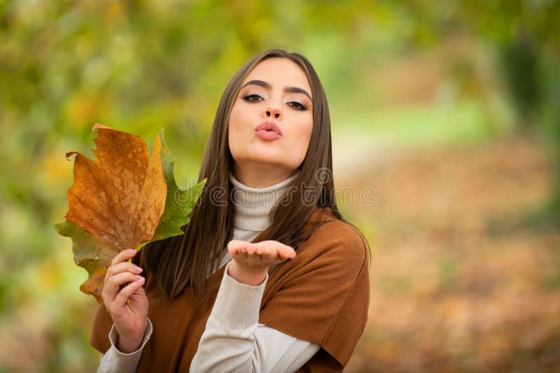 Happy Woman Holding Autumn Leafs On Face In Fall Nature Portrait Of