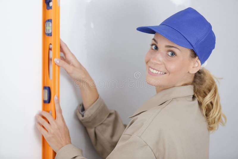 Happy Woman Holding with Both Hands Spirit Level Stock Photo - Image of ... Happy Woman Holding with Both Hands Spirit Level Stock Photo - Image of ...