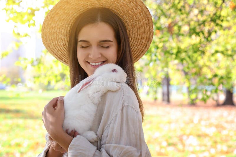 Happy Woman Holding Cute White Rabbit in Park Stock Photo - Image of ...