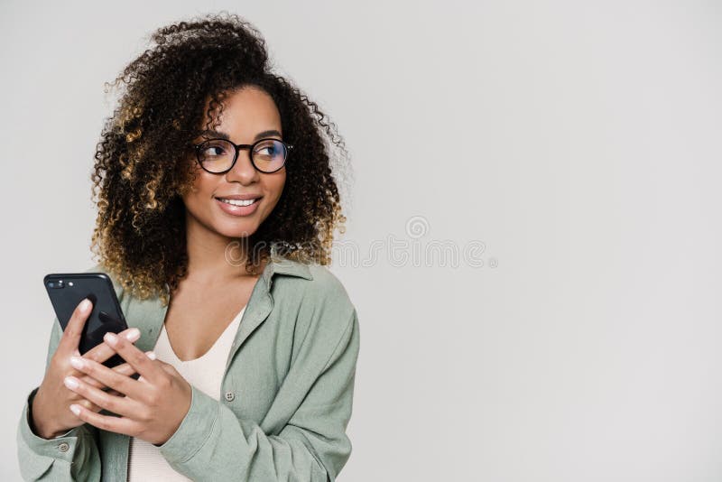 The Happy Woman Holding Phone in Hands and Looking To the Side in the ...