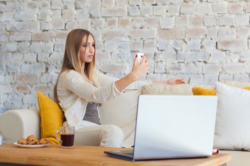 Happy Woman at Home Sitting on Sofa and Doing Selfie. Freelancer ...