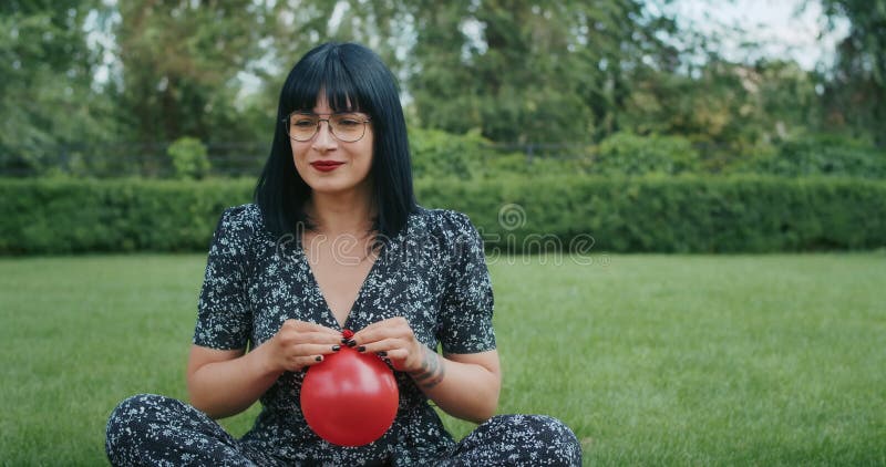 A Happy Woman Inflates Balloons And They Burst Showing That Everything