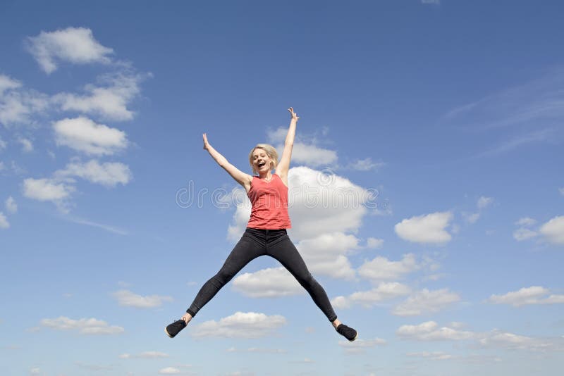 Happy woman jumping stock photo. Image of blonde, dynamic - 71028760