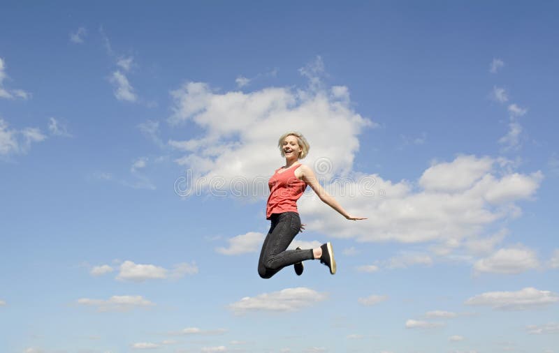Happy woman jumping stock image. Image of girl, female - 71028999
