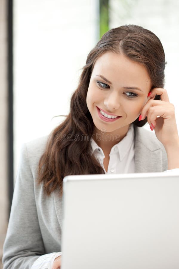 Young Woman on Cell Phone Using Laptop Computer Stock Photo - Image of ...