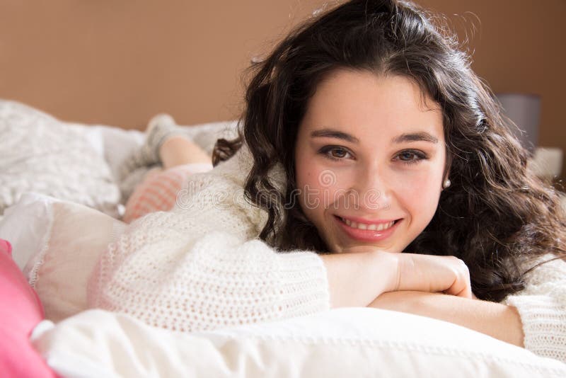 Happy woman lazing in bed stock photo. Image of adult - 61036236