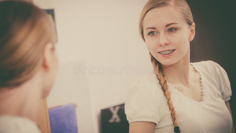 Happy Woman Looking at Her Reflection in Mirror Stock Photo - Image of ...