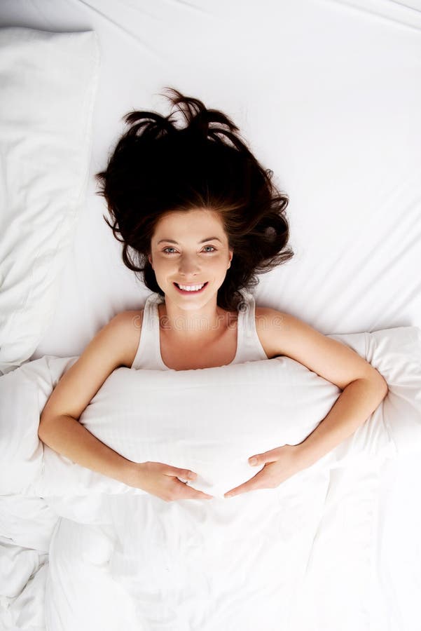 Happy woman lying in bed. stock photo. Image of rest - 55133674