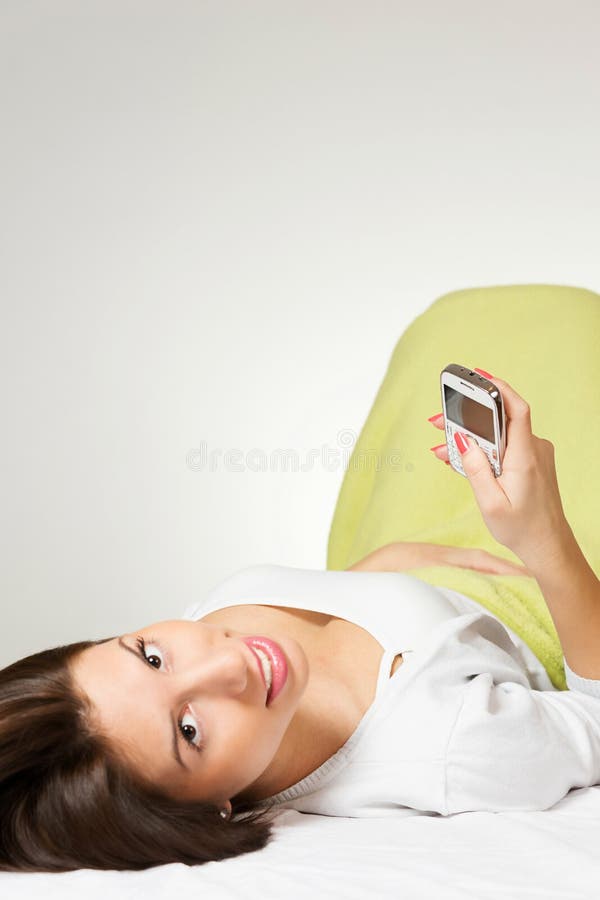Happy Woman Lying on Bed Smiling, Reading a Text Message Stock Image ...
