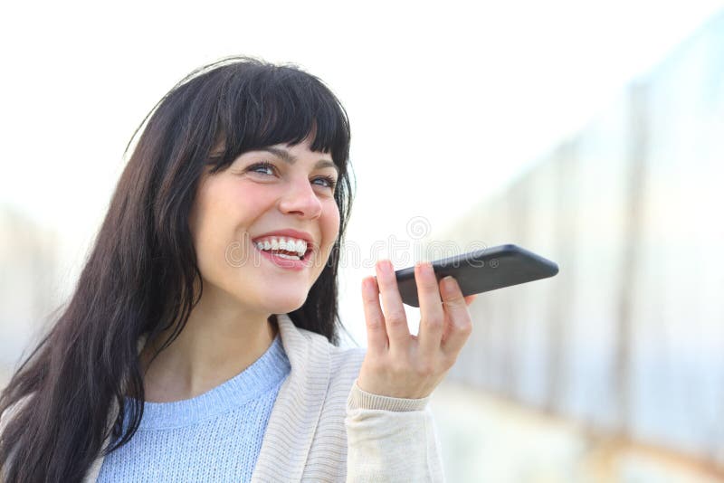 Happy Woman Messaging Using Voice Recognition on Phone Stock Photo ...