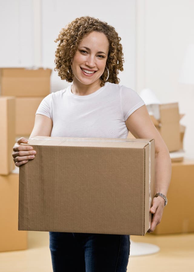 Woman Moving into New Home Hanging Picture Stock Image - Image of ...
