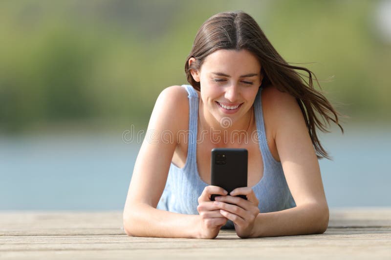 Happy Woman in Nature Using Mobile Phone Stock Photo - Image of phone ...