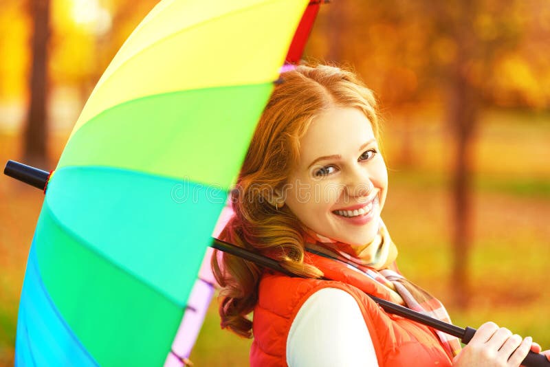 Happy Woman With Rainbow Multicolored Umbrella Under Rain In Par Stock