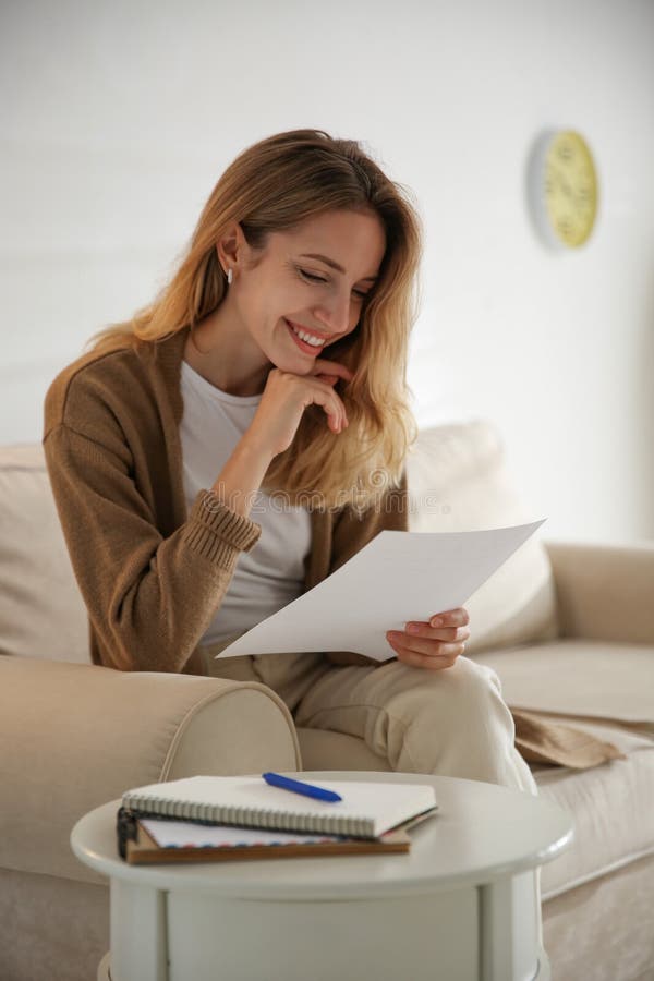 Happy Woman Reading Letter on Sofa at Home Stock Image - Image of ...