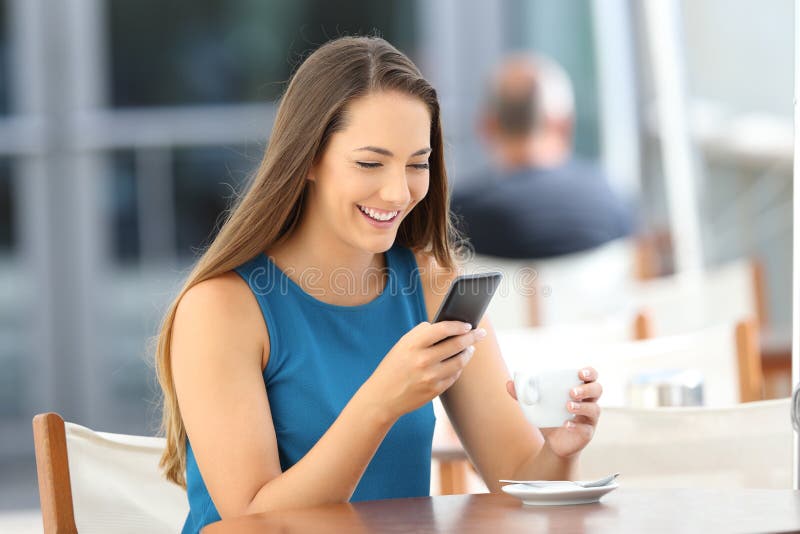 Happy Woman Reading Phone Message in a Bar Stock Image - Image of ...