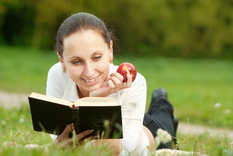 Happy woman reads book stock image. Image of green, outdoors - 16497945