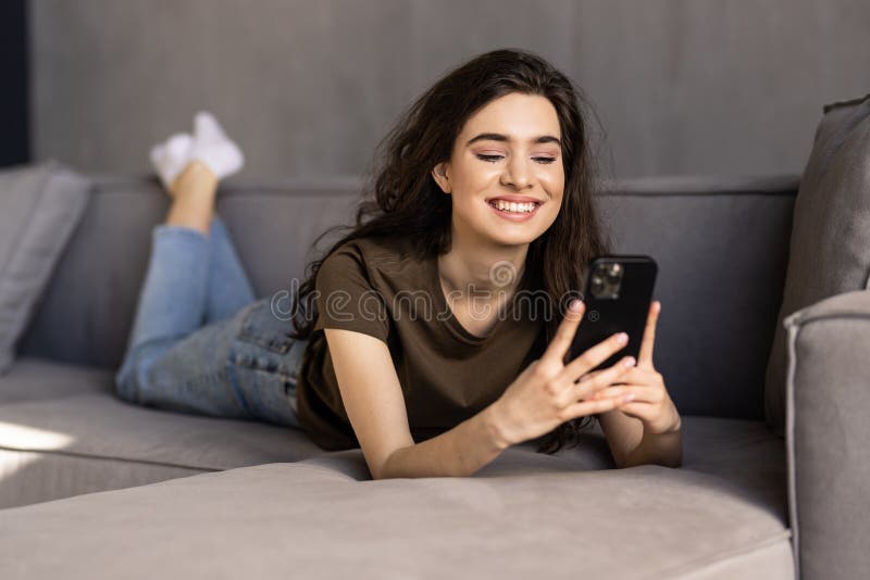 Happy Woman Relaxing on Comfortable Sofa, Enjoying Web Surfing ...