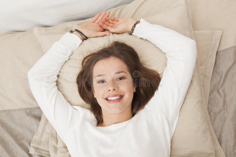 Happy Woman Resting on the Bed Stock Image - Image of angle, horizontal ...