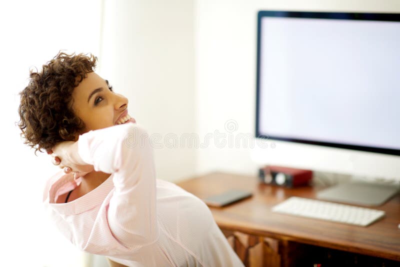 Happy Woman Sitting by Computer with Hands Behind Head Stock Image ...