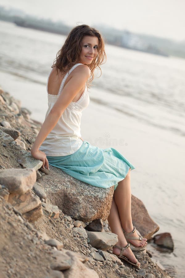 Happy Woman Sitting on Stone Stock Image - Image of gorgeous, beautiful ...