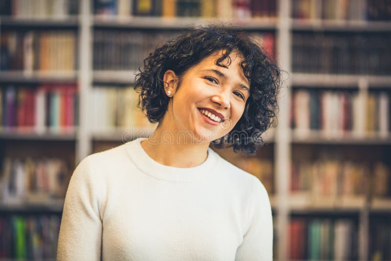 Woman Standing in Library and Looking at Camera Stock Photo - Image of ...
