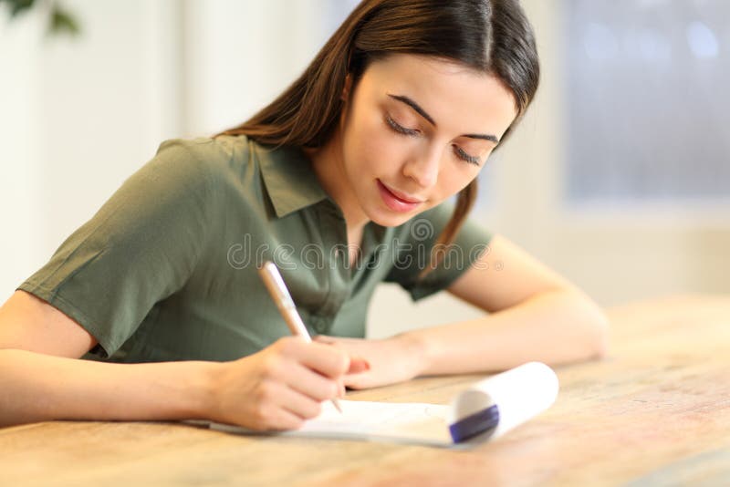 Happy Woman Taking Notes on Paper Notebook on Table Stock Photo - Image ...