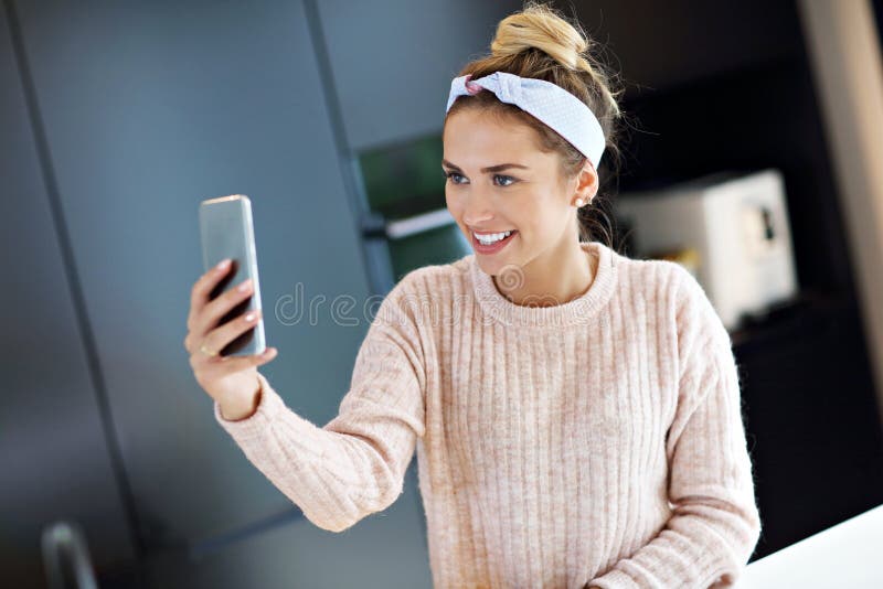 Happy Woman Texting in the Kitchen Stock Image - Image of woman, happy ...