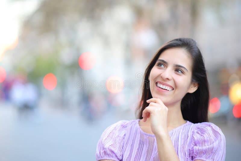 Happy Woman Thinking Looking at Side in the Street Stock Image - Image ...