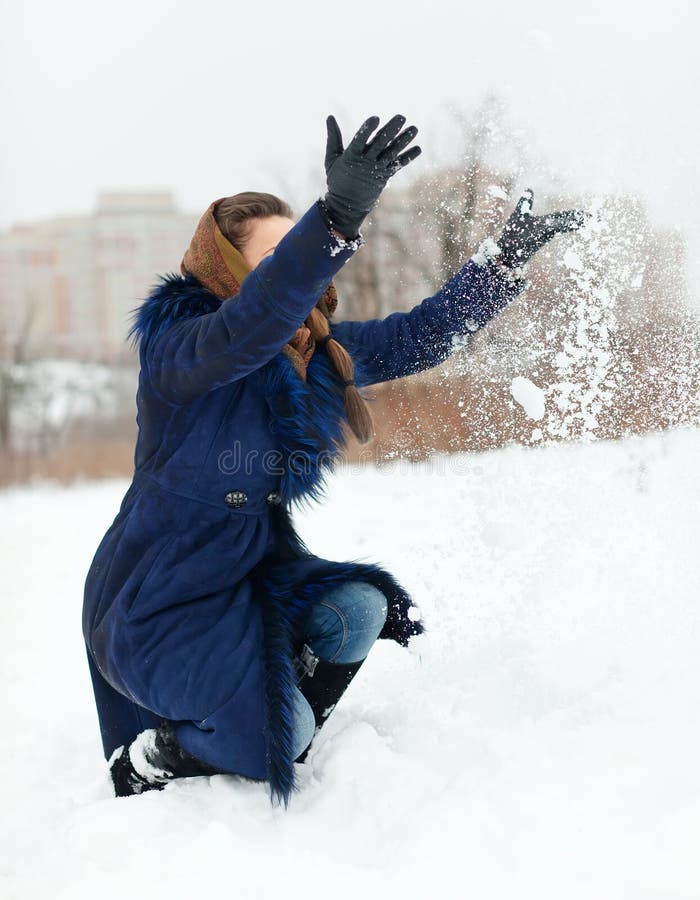 Happy woman throwing snow stock image. Image of playful - 29952797