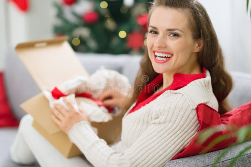 Happy Woman Unpacking Parcel with Christmas Gift Stock Photo - Image of ...