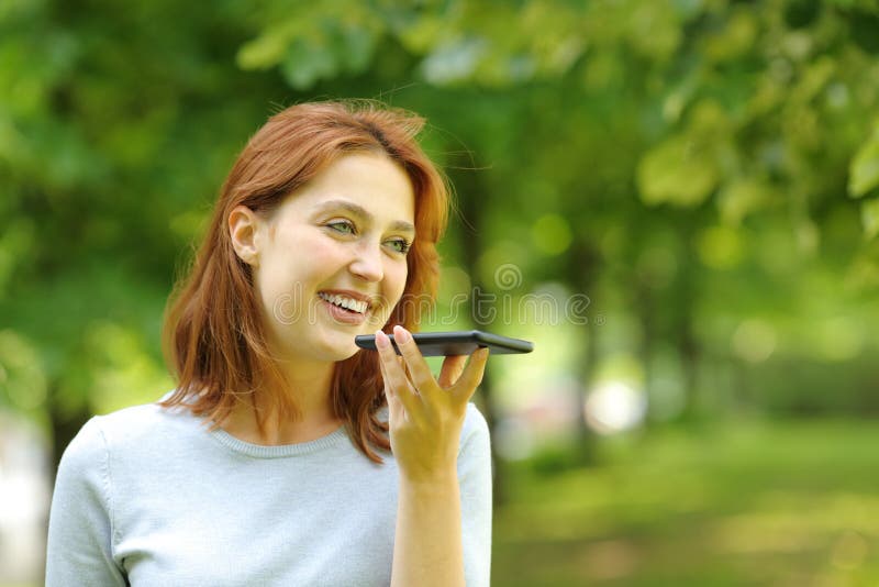 Happy Woman Uses Voice Recognition on Phone in a Park Stock Photo ... Happy Woman Uses Voice Recognition on Phone in a Park Stock Photo ...