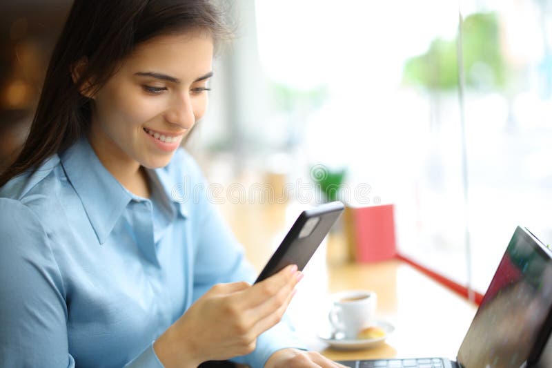 Happy Woman Using Cell Phone and Tablet in a Bar Stock Photo - Image of ...
