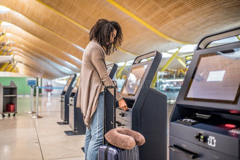 Happy Woman Using the Check-in Machine at the Airport Getting Th Stock ...