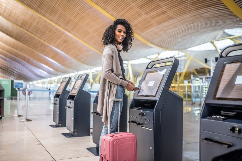 Happy Woman Using the Check-in Machine at the Airport Getting Th Stock ...