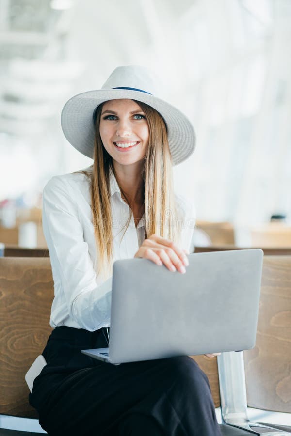 Happy Woman Using Laptop Computer at Airport Stock Image - Image of ...